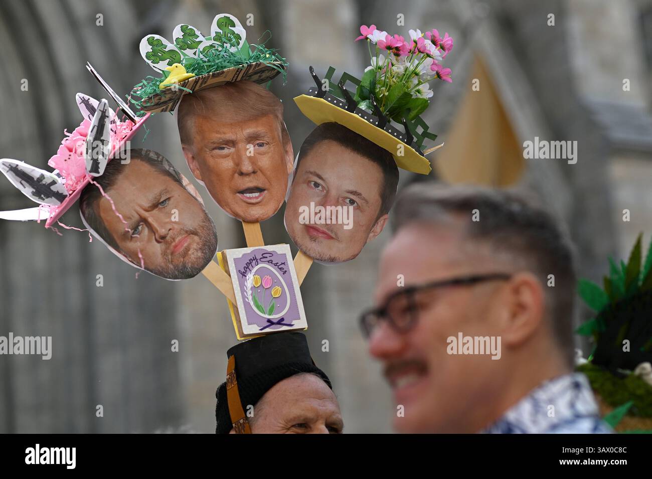 New York, USA. 20th Apr, 2025. A parade participant holds a sign with ...