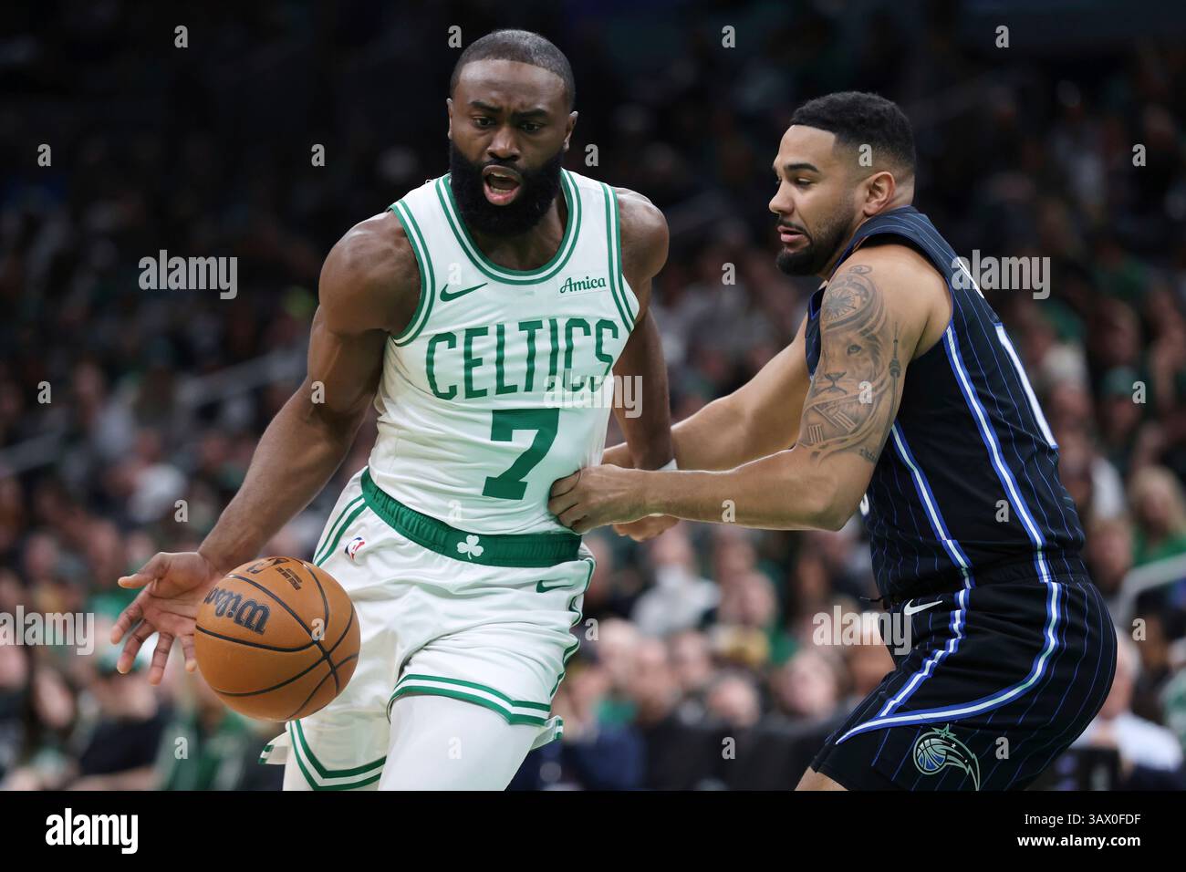 Boston Celtics' Jaylen Brown (7) drives past Orlando Magic's Cory ...