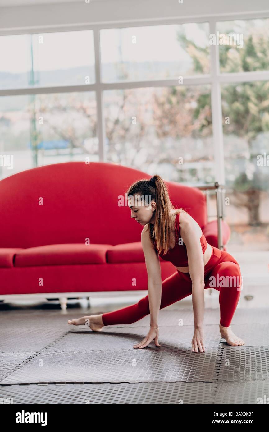 Grounded intensity in deep stretch pose where control meets inner tension Stock Photo - Alamy