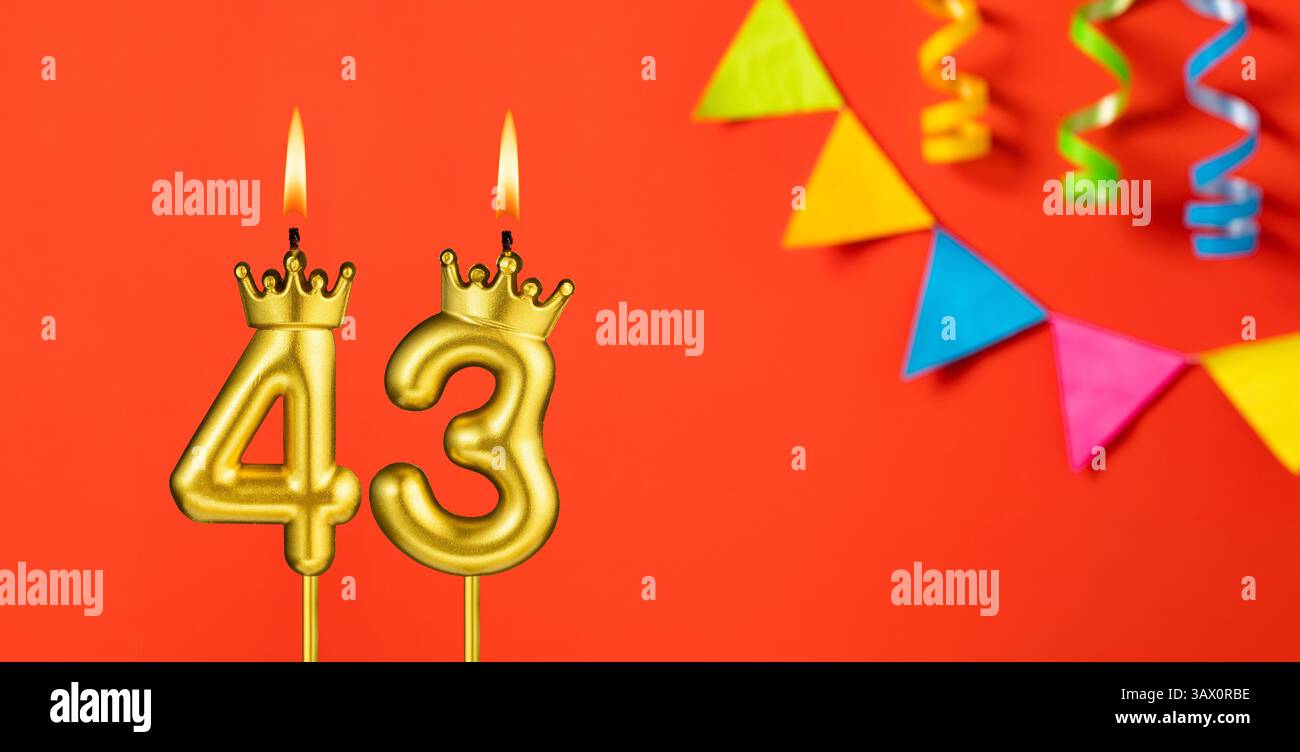 Number 43 birthday candle on an orange background with pennants Stock ...