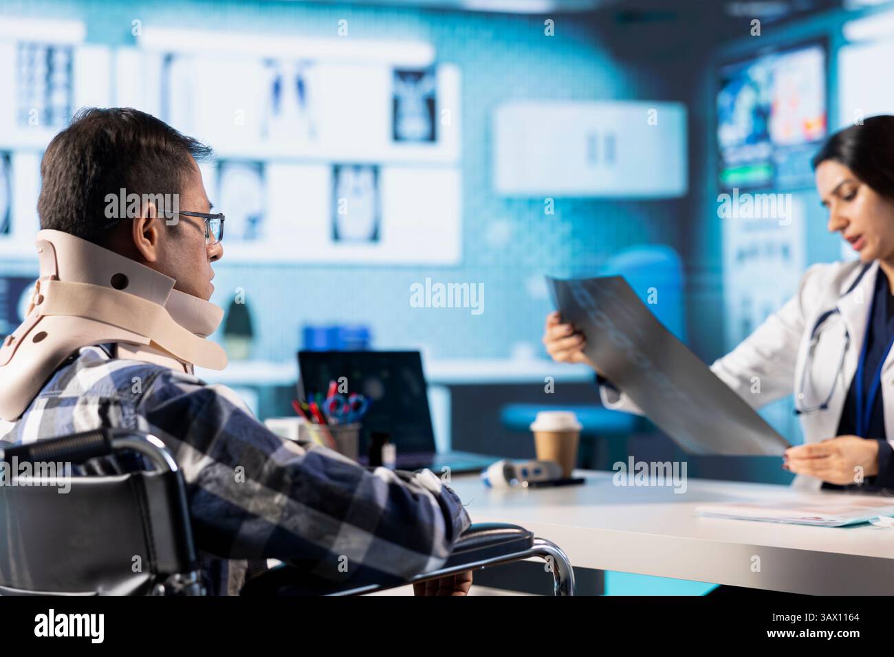 Indian medic reviewing x ray imaging test findings to patient with ...