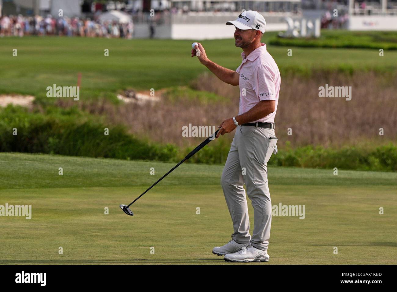 Brian Harman waves to the gallery after making a putt on the 18th green ...