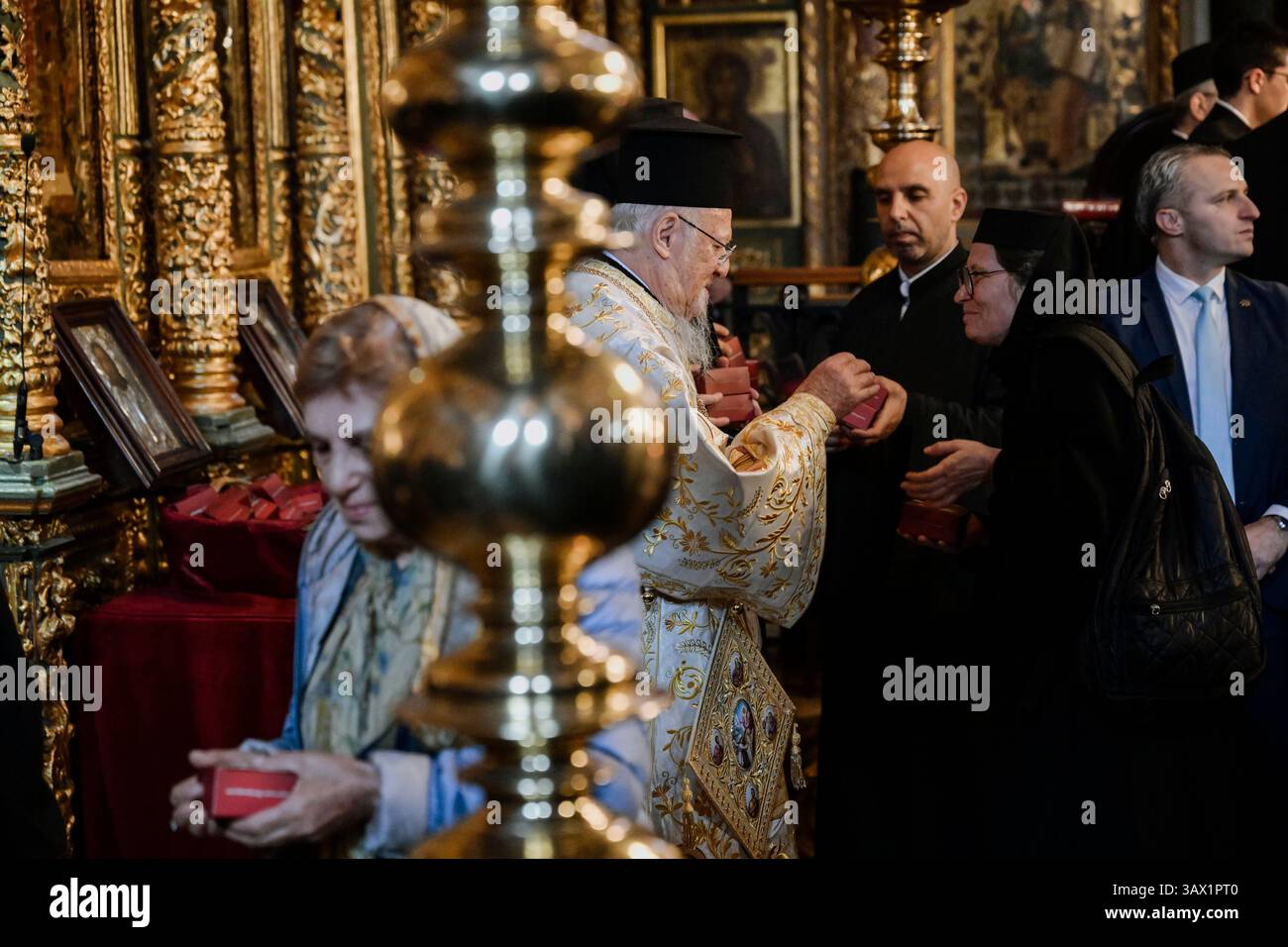 People seen receiving presents from the Ecumenical Patriarch Bartholomew I (C) during the ...