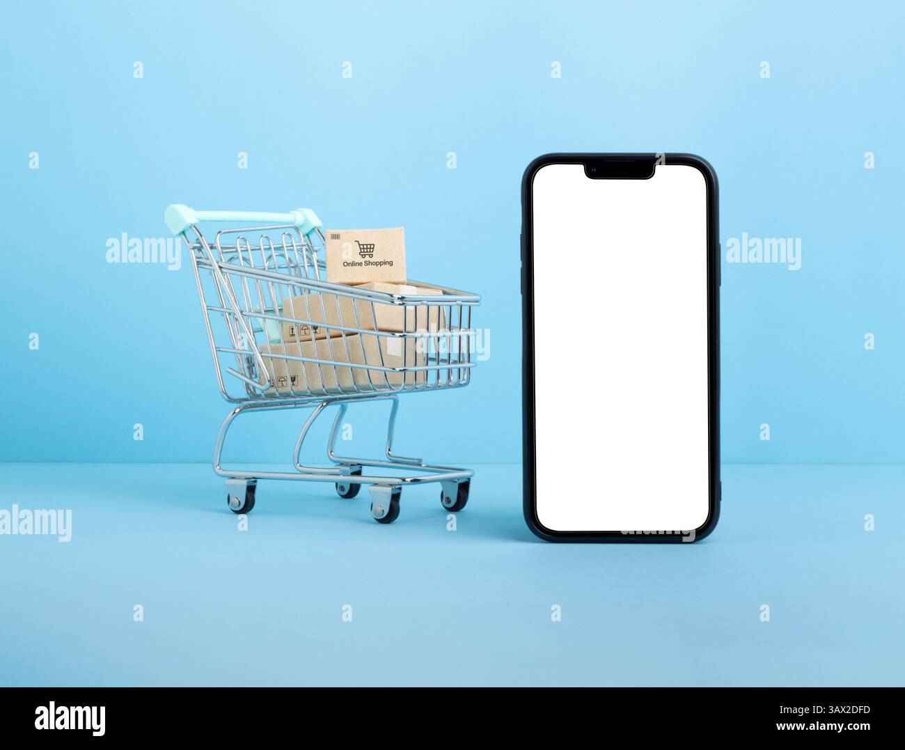 Shopping cart filled with small packages placed beside a smartphone ...