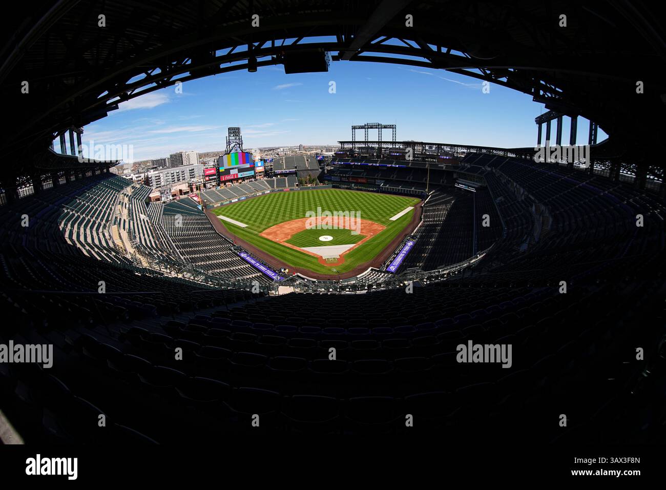 As viewed through a fisheye lens, workers toil to prepare Coors Field ...