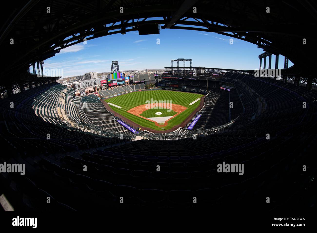 As viewed through a fisheye lens, workers toil to prepare Coors Field ...