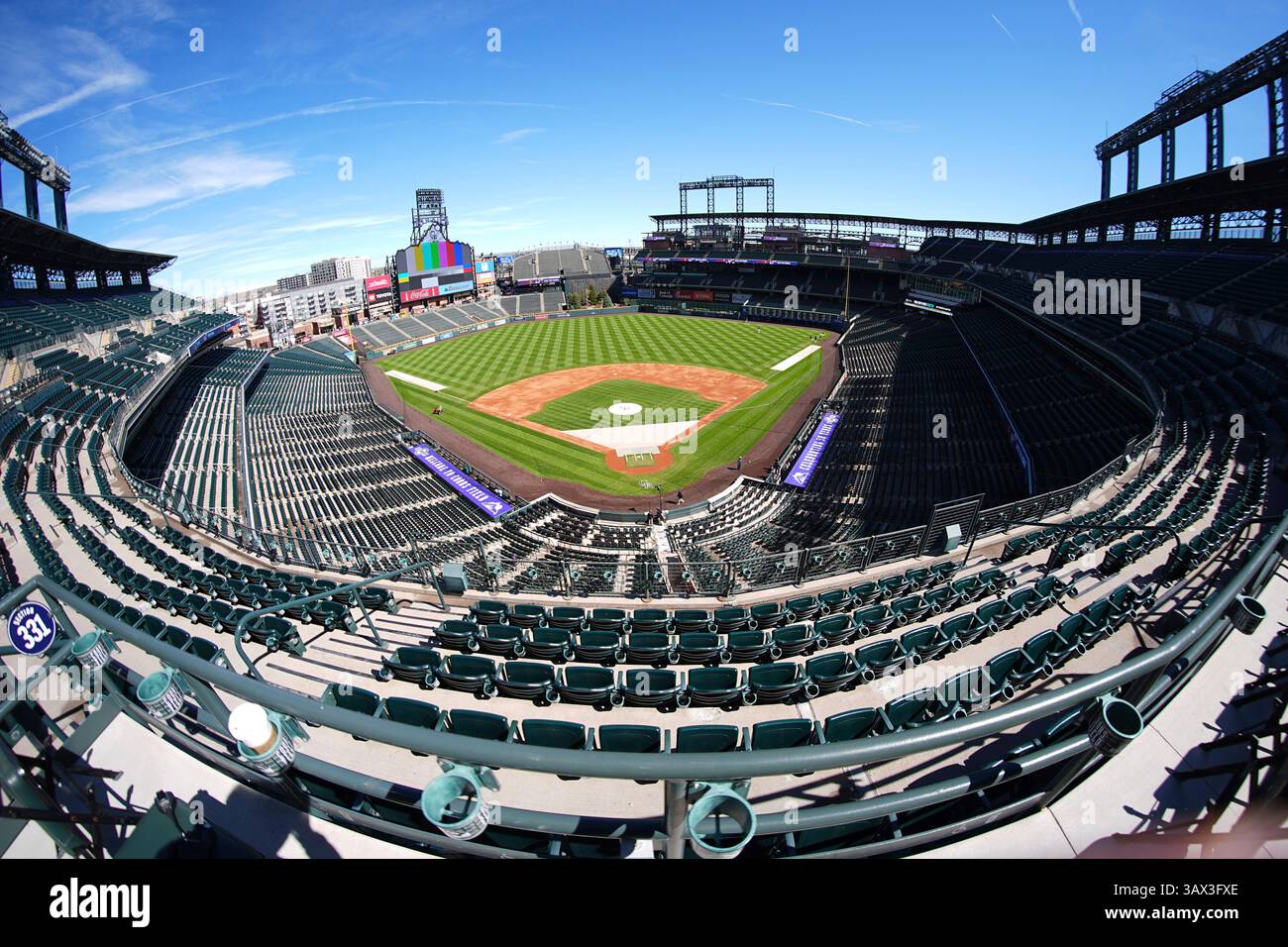 As viewed through a fisheye lens, workers toil to prepare Coors Field ...