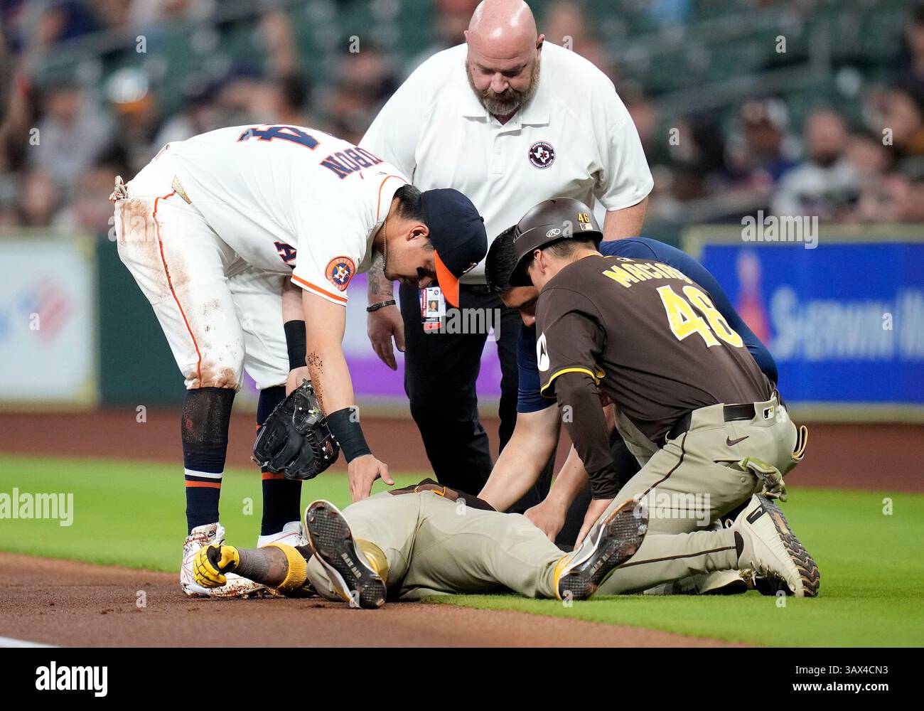 San Diego Padres' Luis Arraez lies on the ground after a collision with ...