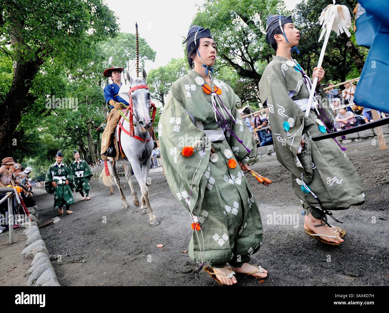 A horseback archer dressed in a traditional hunting garb is escorted ...