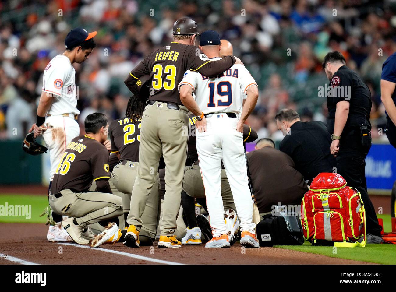 San Diego Padres third base coach Tim Leiper (33) hugs Houston Astros ...
