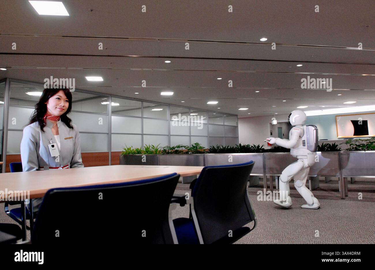 Honda Motor Co.'s humanoid robot ASIMO carries drinks across an office ...