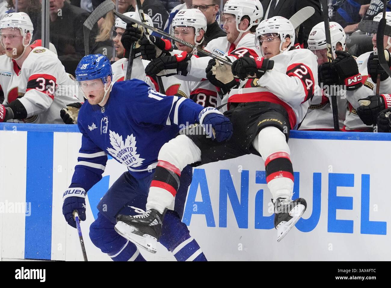 Toronto Maple Leafs Steven Lorentz (18) checks Ottawa Senators Dylan ...