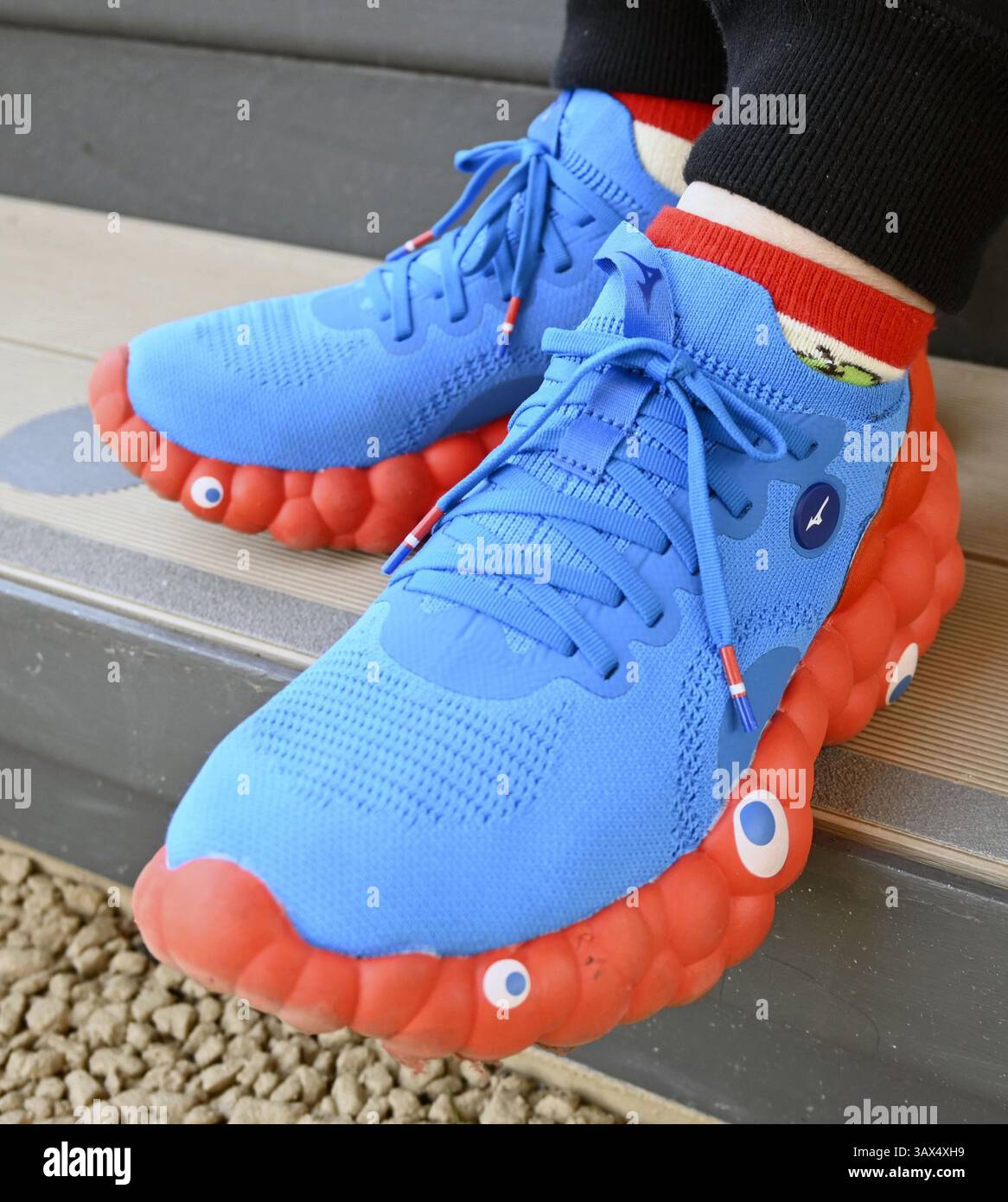 A visitor wears shoes featuring Myaku-Myaku, the official mascot of the ...