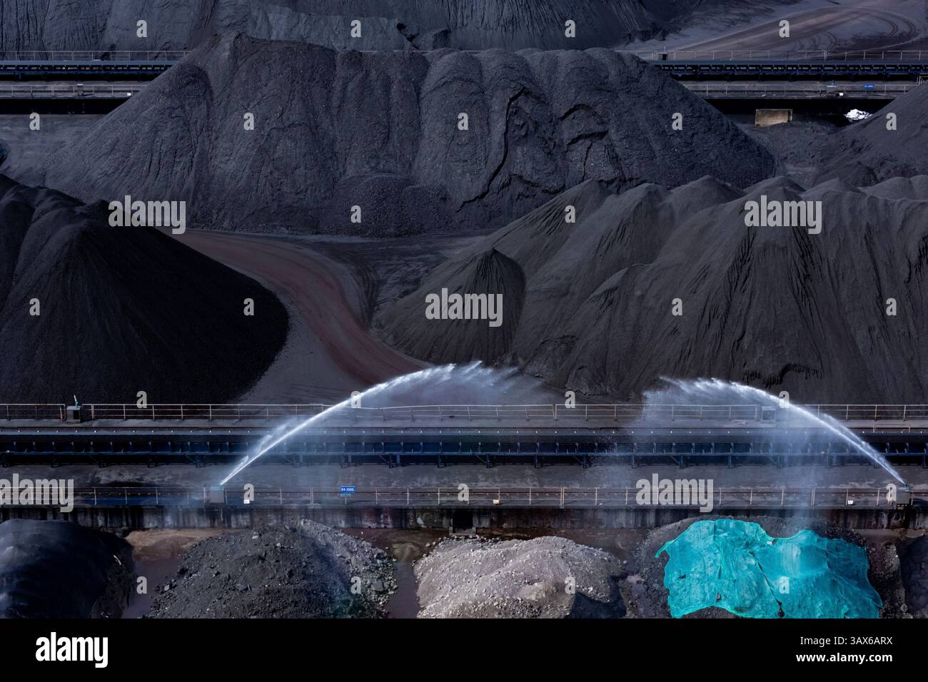 Nozzles spray water to cool off a coal yard at a port on the Yangtze ...