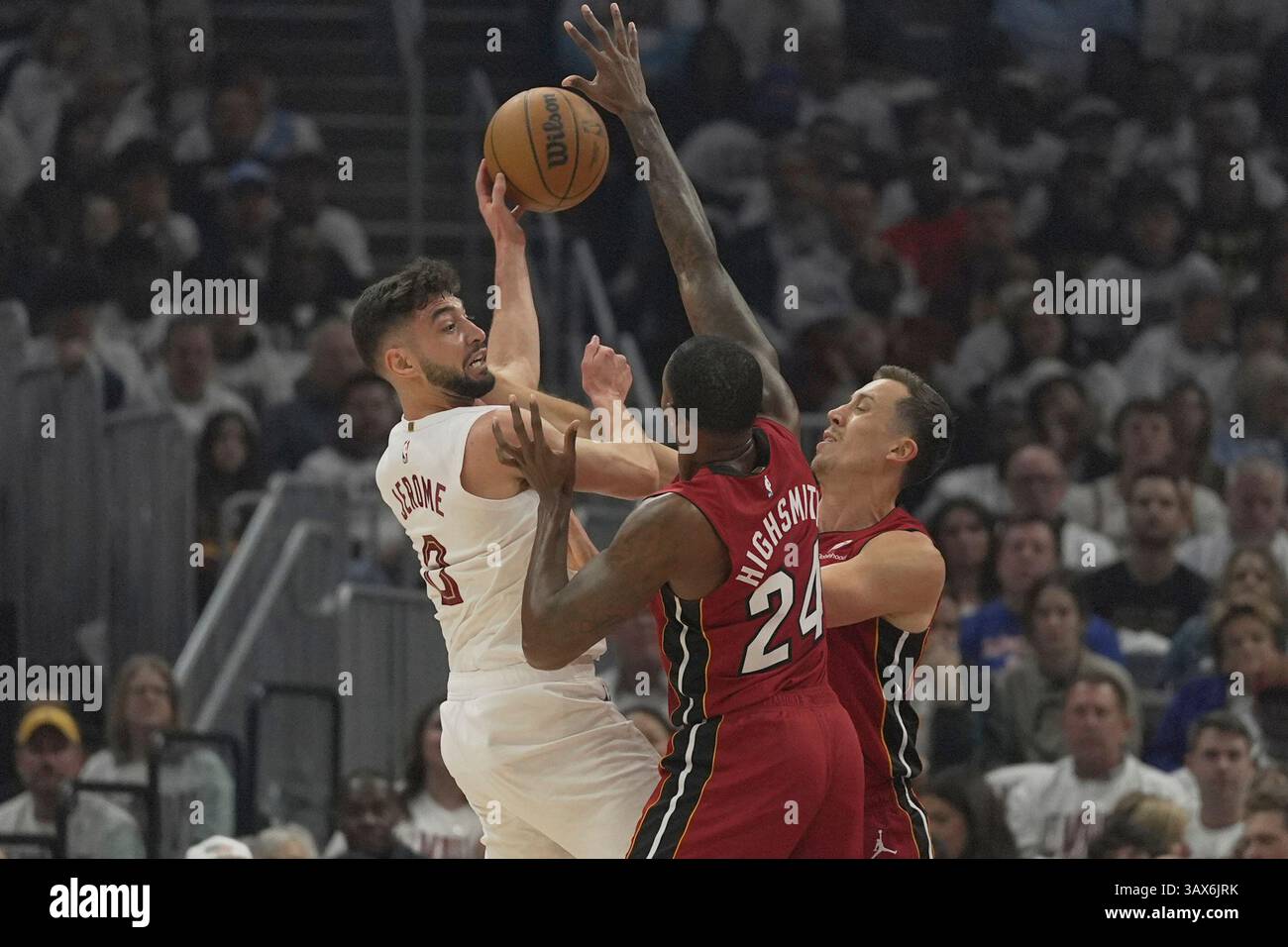 Cleveland Cavaliers guard Ty Jerome, left, passes over Miami Heat ...