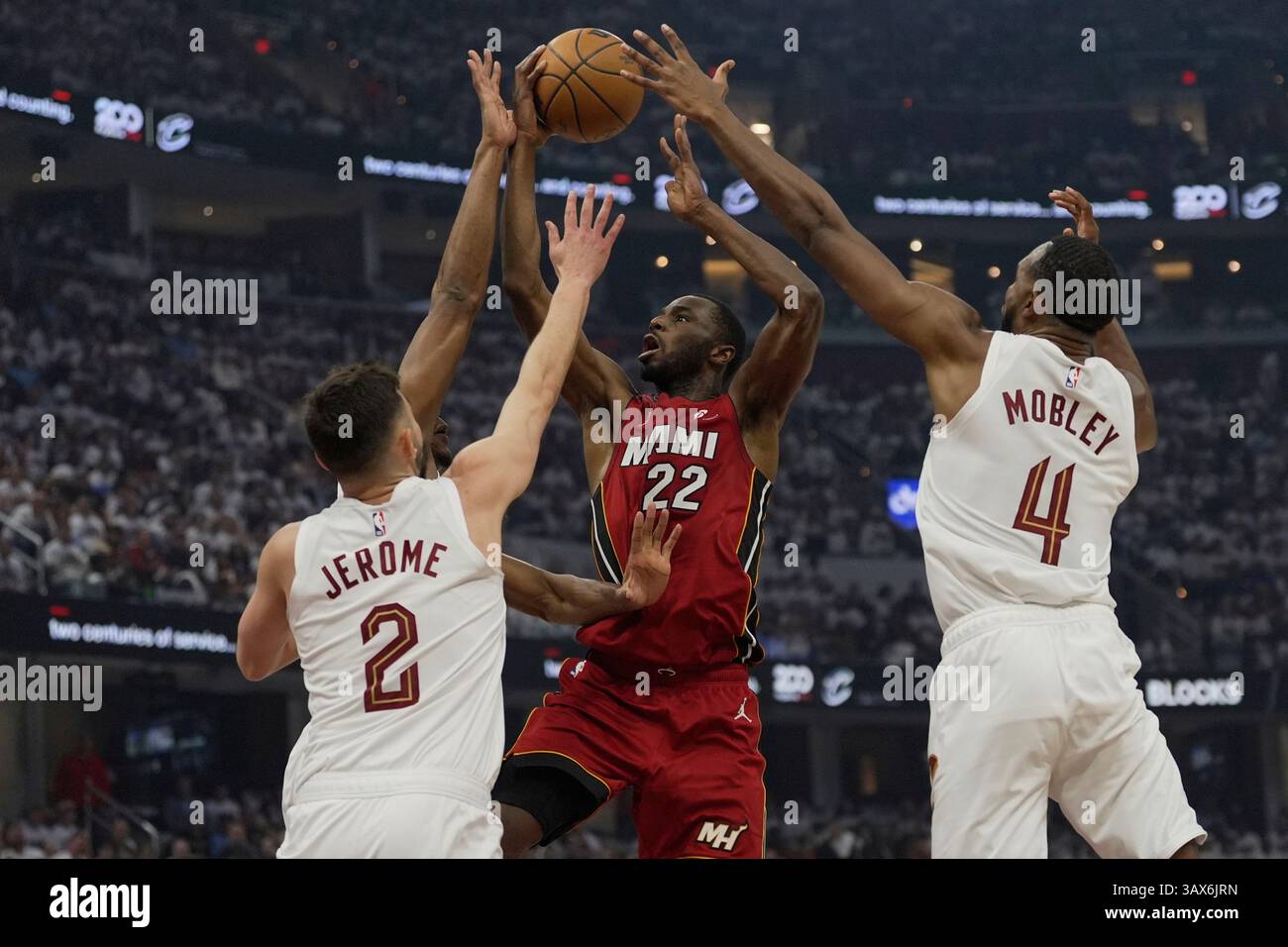 Miami Heat forward Andrew Wiggins (22) shoots between Cleveland ...