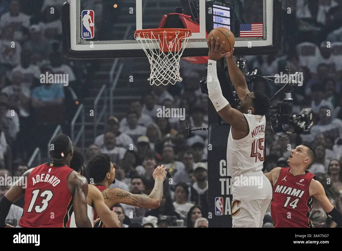 Cleveland Cavaliers guard Donovan Mitchell (45) goes up for a dunk between Miami Heat center Bam ...