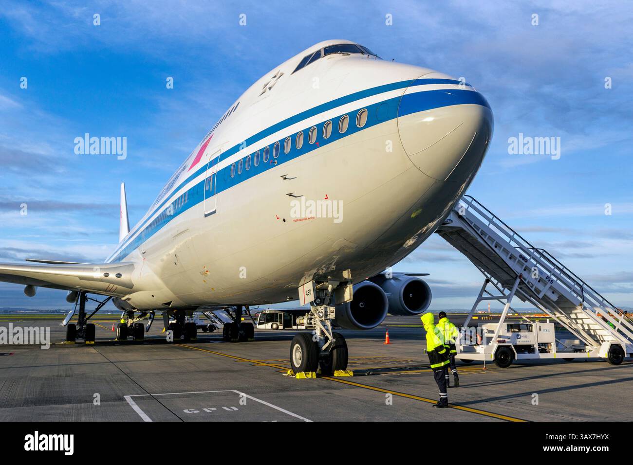 An Air China Boeing 747 aircraft parked at the airport with ground crew ...
