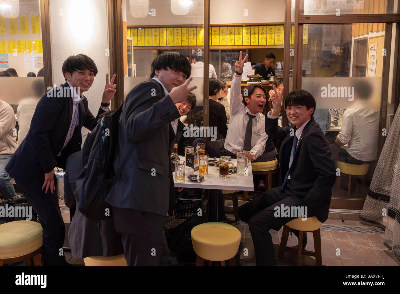 Yokohama, Japan. 18th Apr, 2025. Japanese office workers gesture a ...