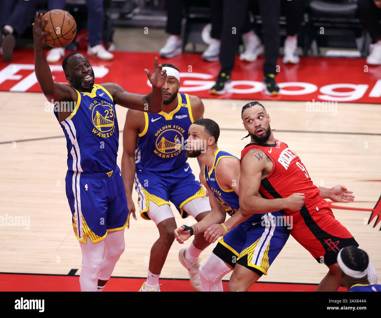 Golden State Warriors' Draymond Green (25) grabs a rebound as Stephen Curry, third from left ...