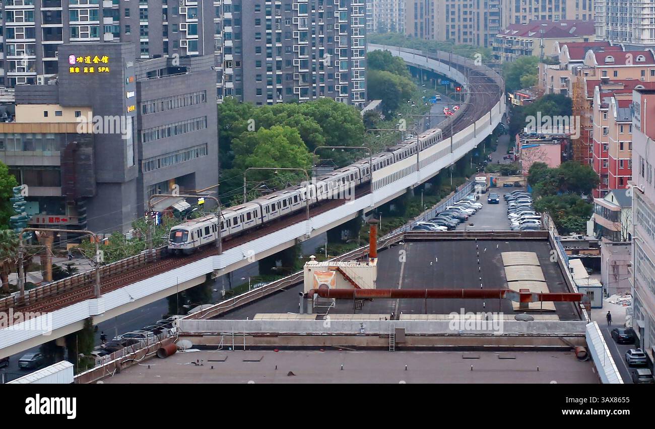 Shanghai Metro Line 3 runs among high-rise buildings in Shanghai, China ...