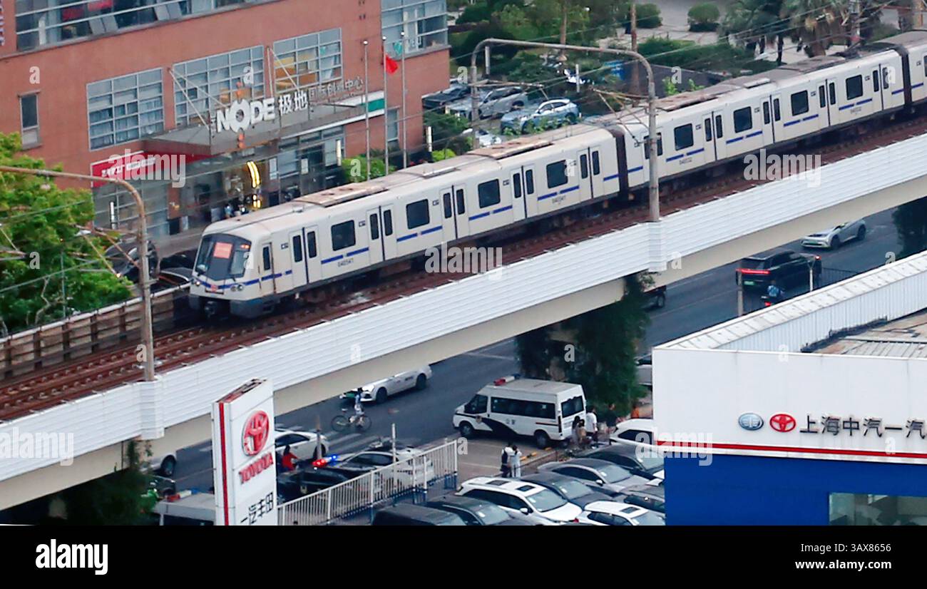 Shanghai Metro Line 3 runs among high-rise buildings in Shanghai, China ...