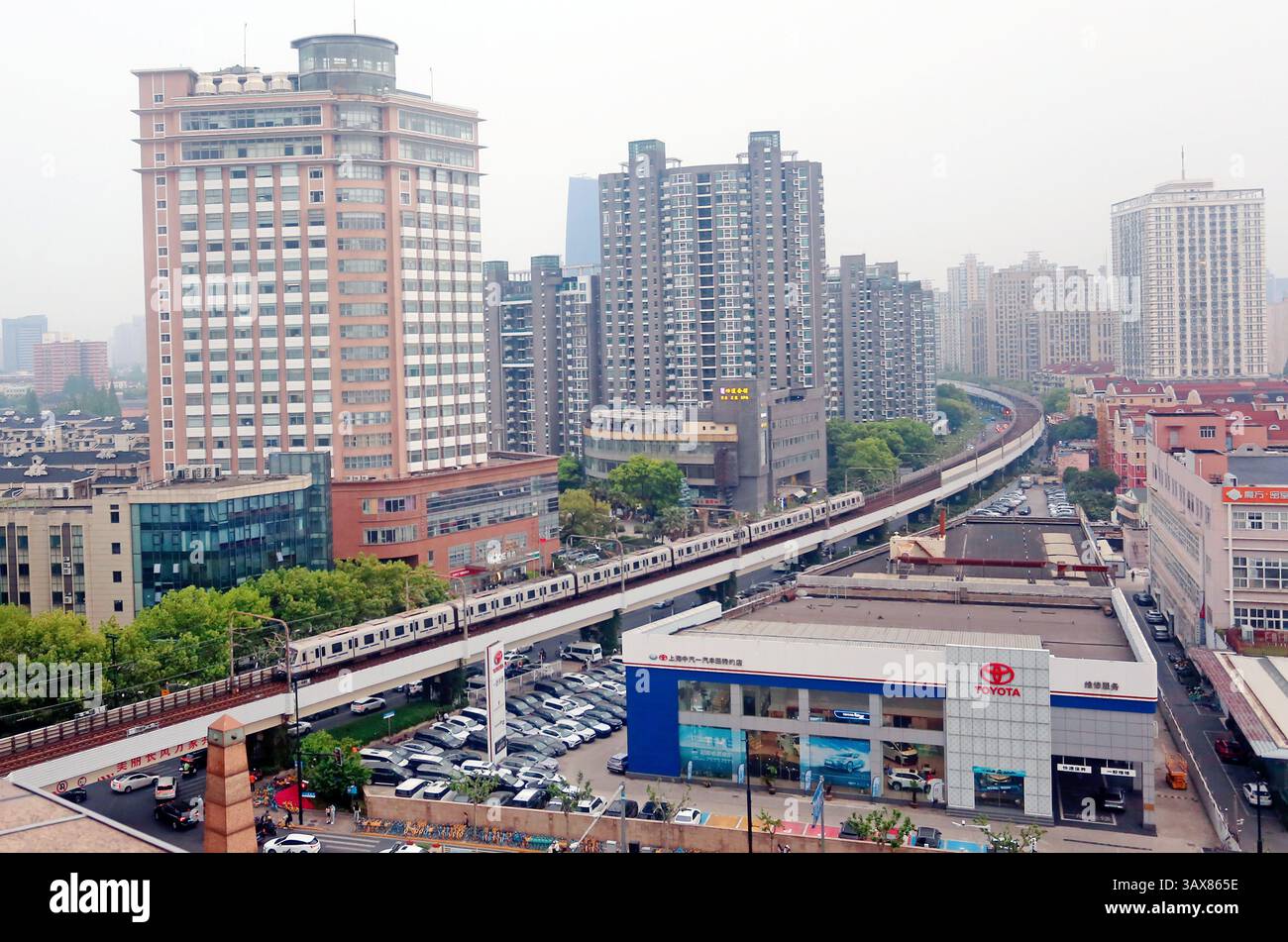 Shanghai Metro Line 3 runs among high-rise buildings in Shanghai, China ...