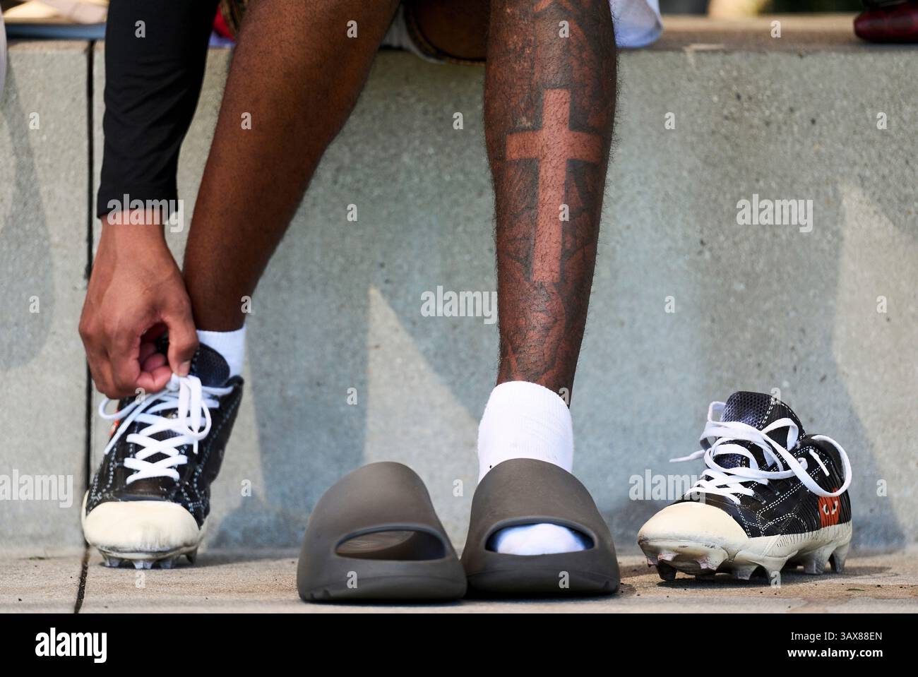 Wide receiver Tory Horton puts on his cleats as he prepares for the NFL ...