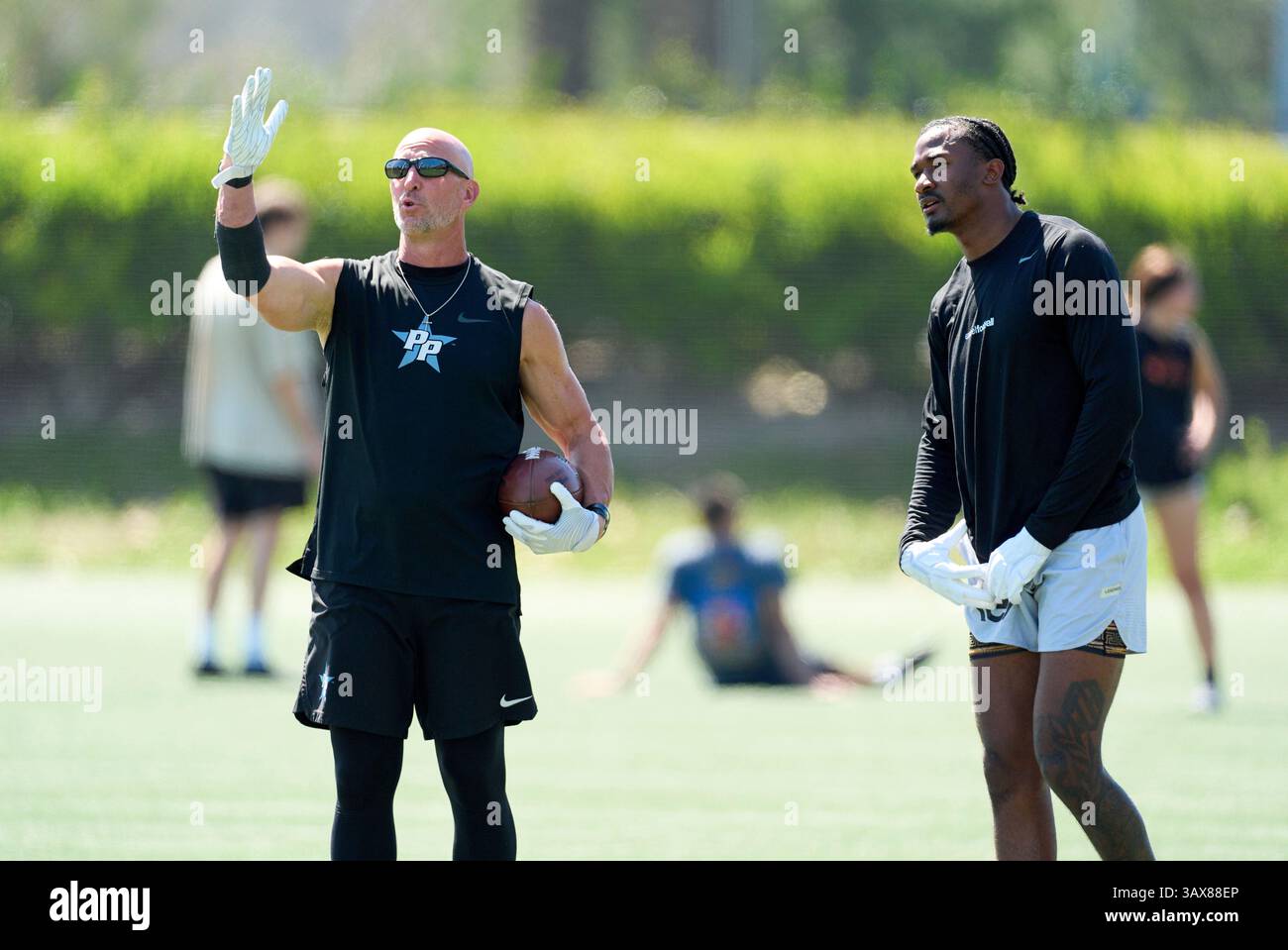 Coach Rick Proehl, left, works with wide receiver Tory Horton in ...