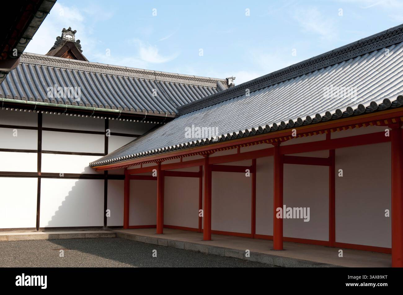 A covered walkway with a vermilion colonnade and kawara tile roof is an ...