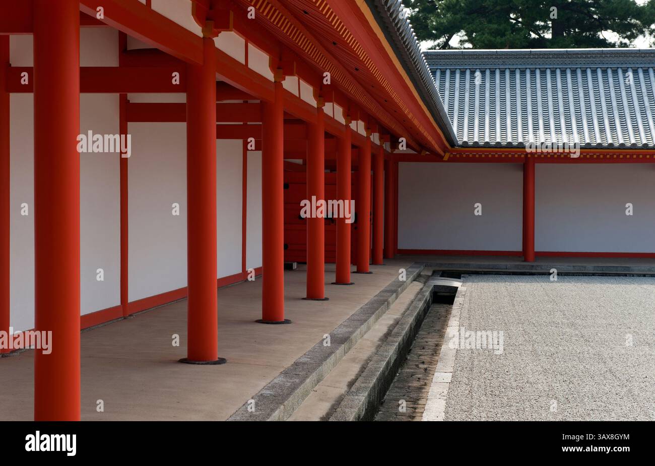 A covered walkway with a vermilion colonnade and kawara tile roof is an ...