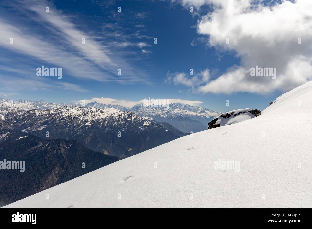 majestic snow-covered peaks with fresh snowfall under clear blue ...