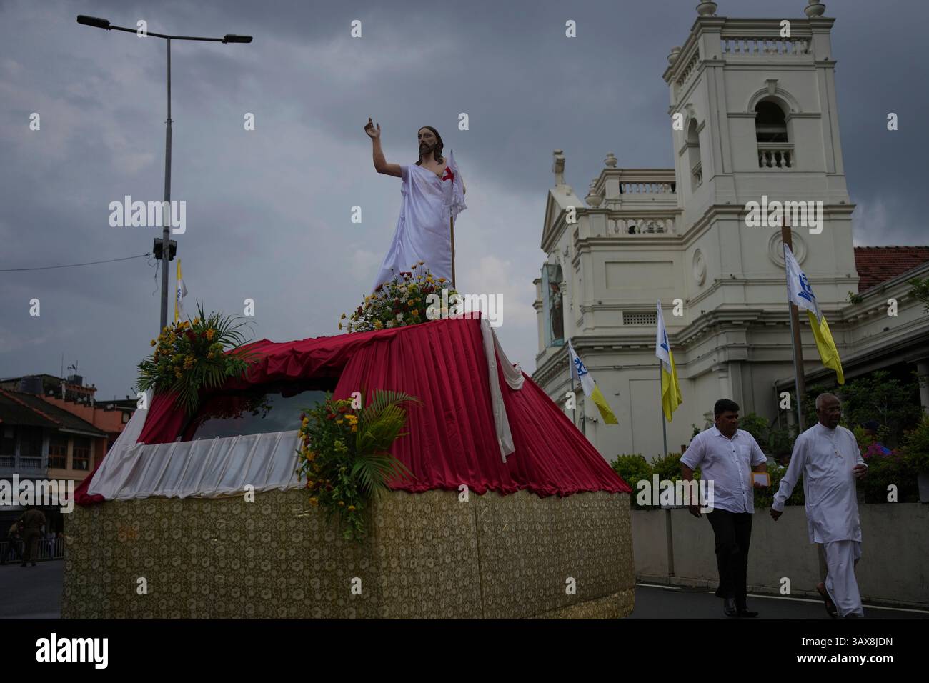 Sri Lankan Catholics walk past a statue of Jesus Christ outside St ...