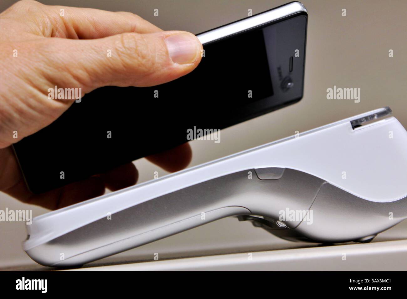 Smartphone, POS terminal, and credit card shown in closeup on white ...
