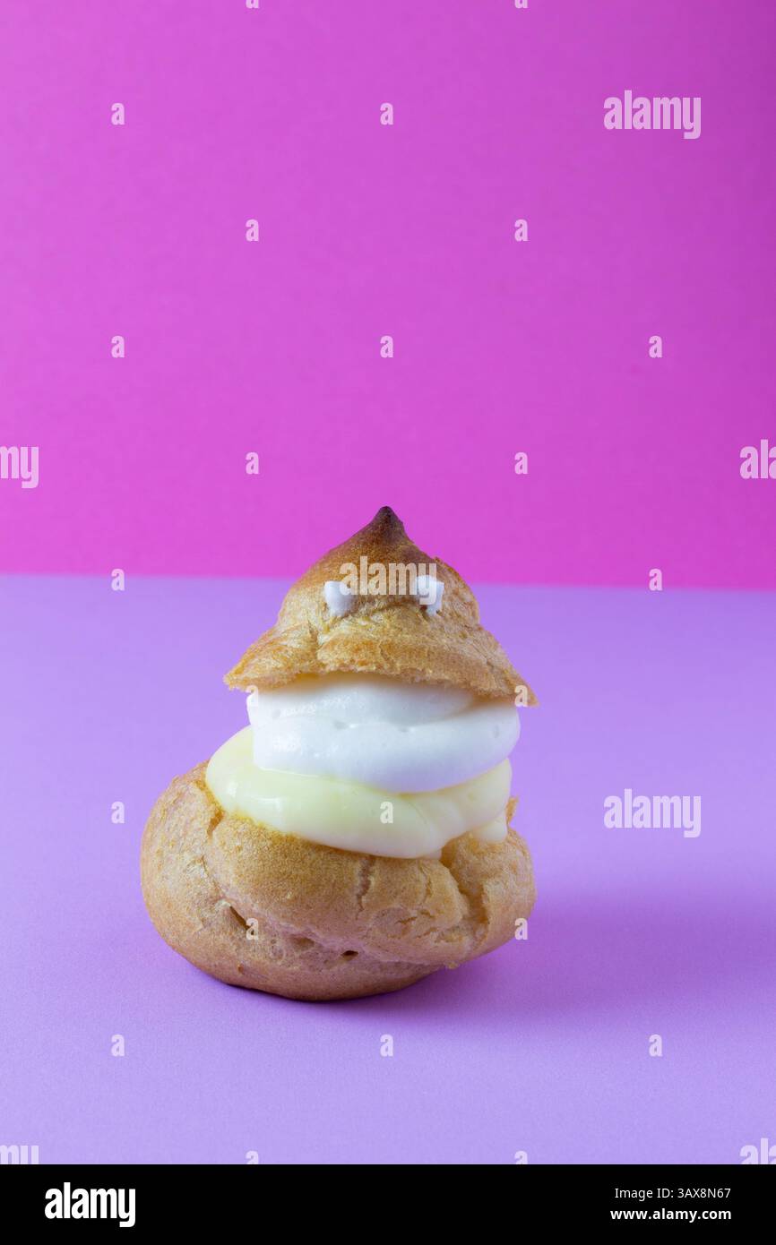 Cream puffs with a pink-purple background Stock Photo - Alamy