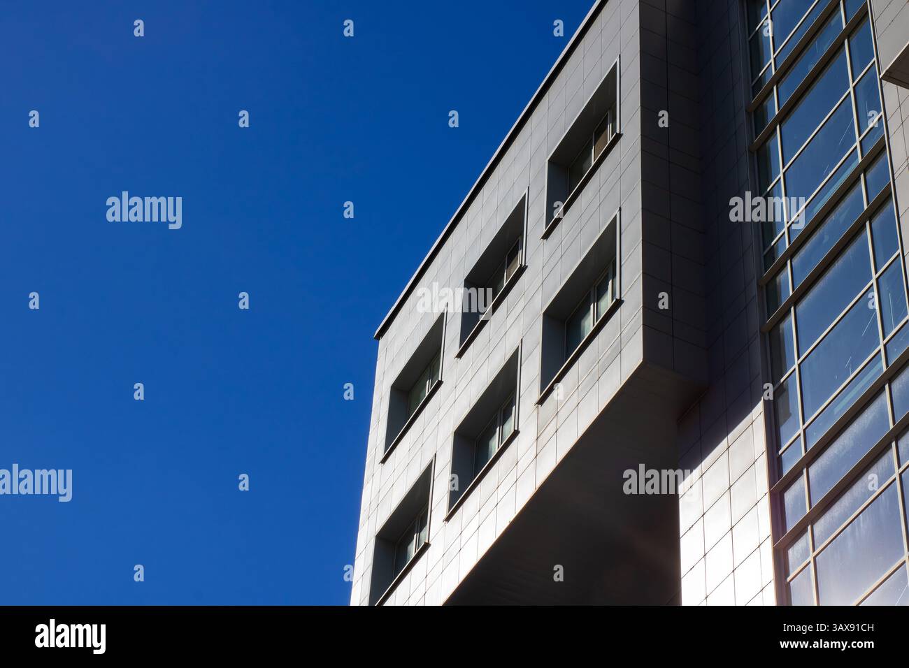 A tall building featuring numerous windows stands proudly against the ...