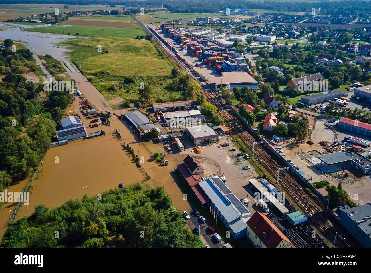 Aerial view of flooded streets, railway tracks and buildings in a ...