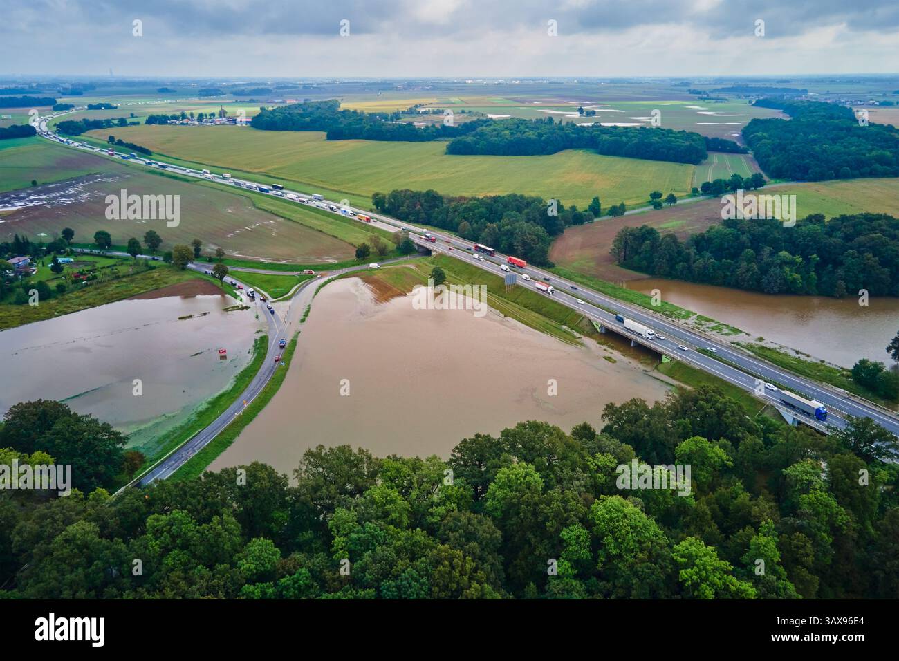 Aerial view of flooded fields and submerged rural road near busy ...