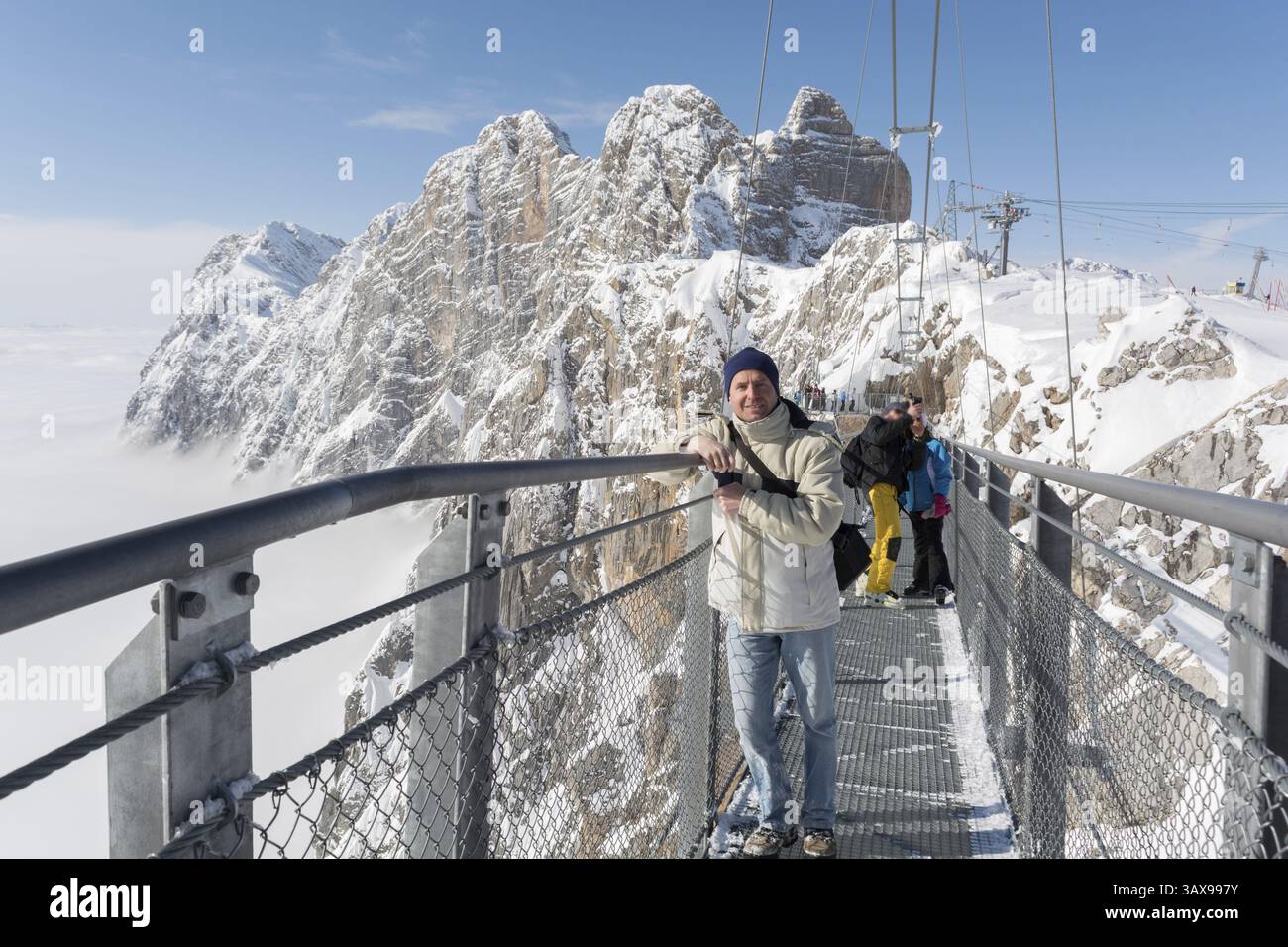 Dachstein suspension bridge with a person standing on it, the Dachstein ...