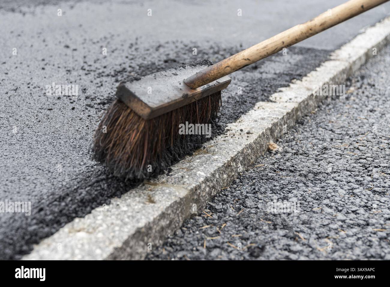 Sweeping broom during asphalting work in road construction - close-up ...
