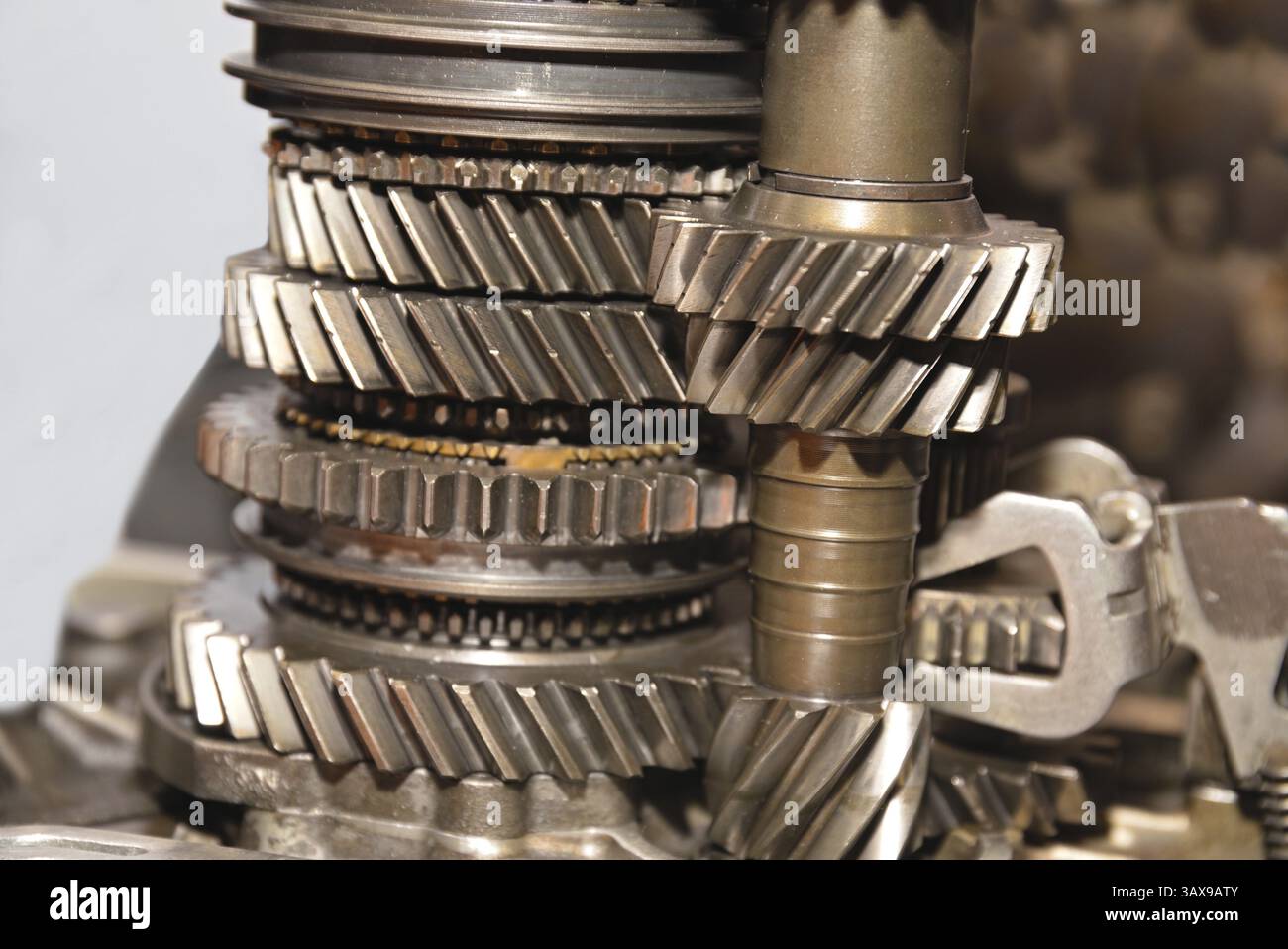 Numerous gears with strong teeth in the barrel of a gearbox - close-up ...