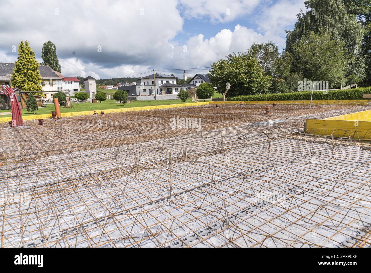 House construction site with steel grid for concrete foundation slab ...