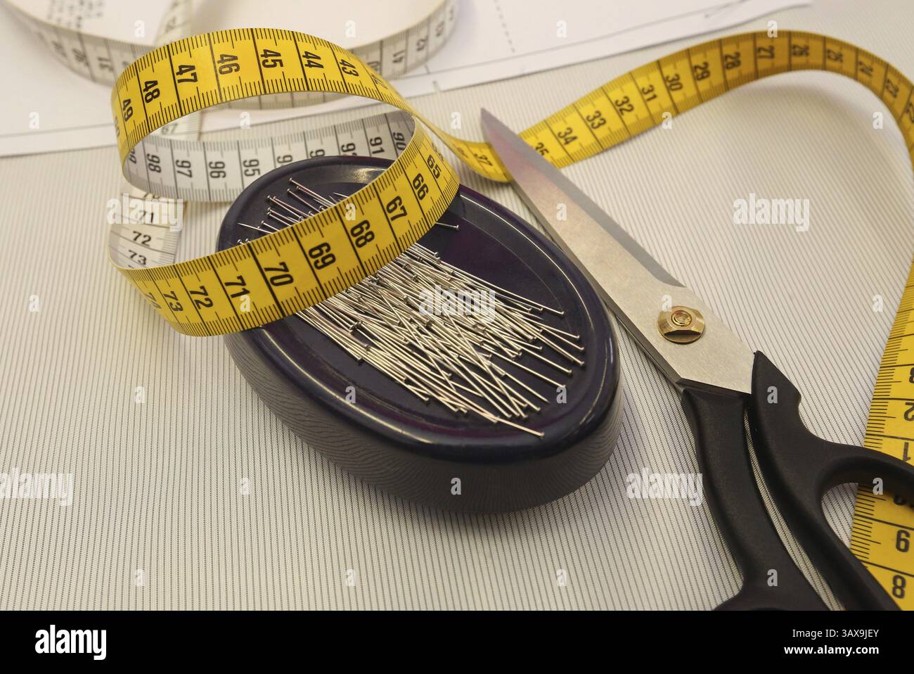 Needles, tape measure and scissors Stock Photo - Alamy