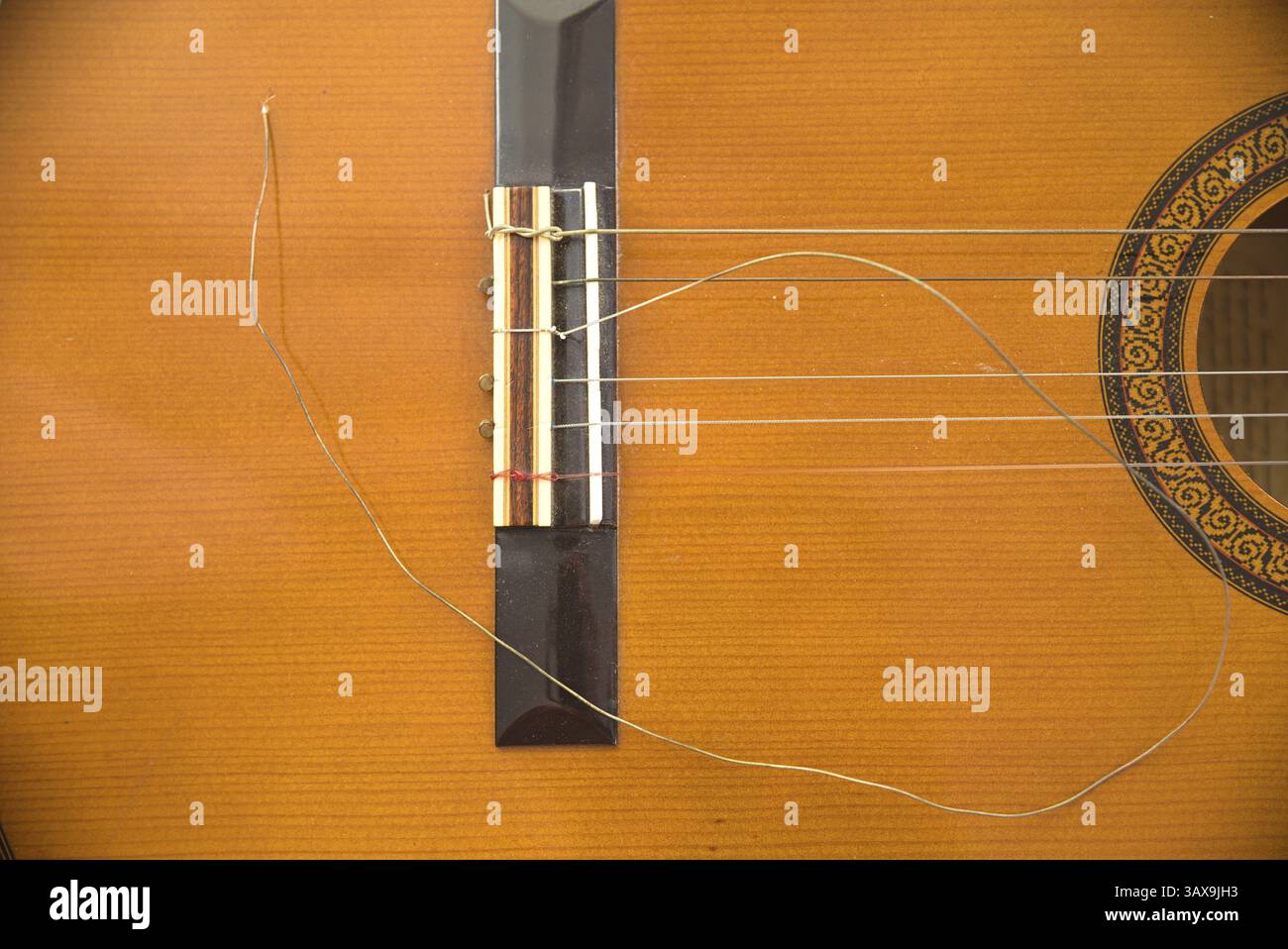 Broken string of the classical musical instrument guitar - close-up ...