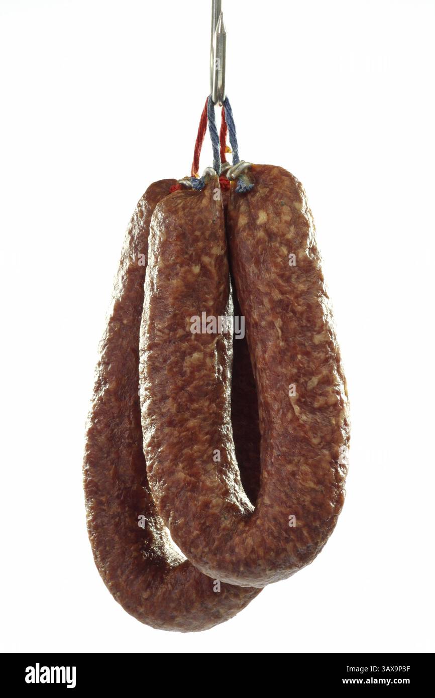 Homemade mettwurst on a hook - cropped on a white background Stock ...
