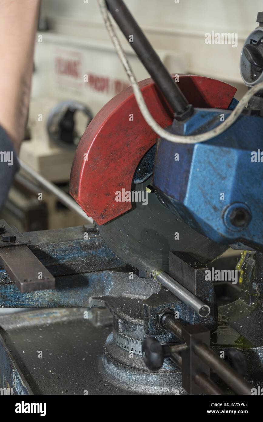 Craftsman cutting metal with a metal circular saw - close-up mitre saw ...