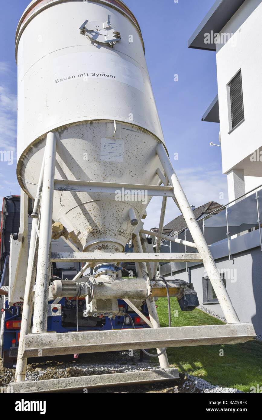 Construction company erects a concrete silo on a building site ...