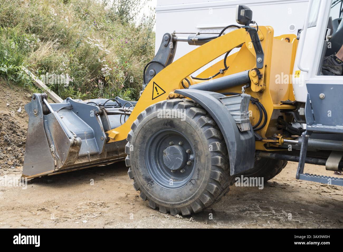 Wheel loader on a construction site during earthworks - Front loader in ...
