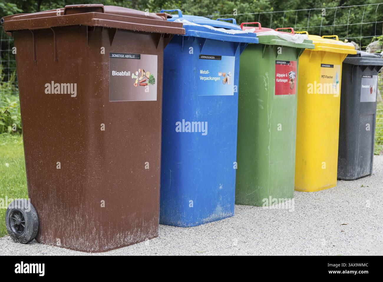 Different coloured bins according to waste separation system ...