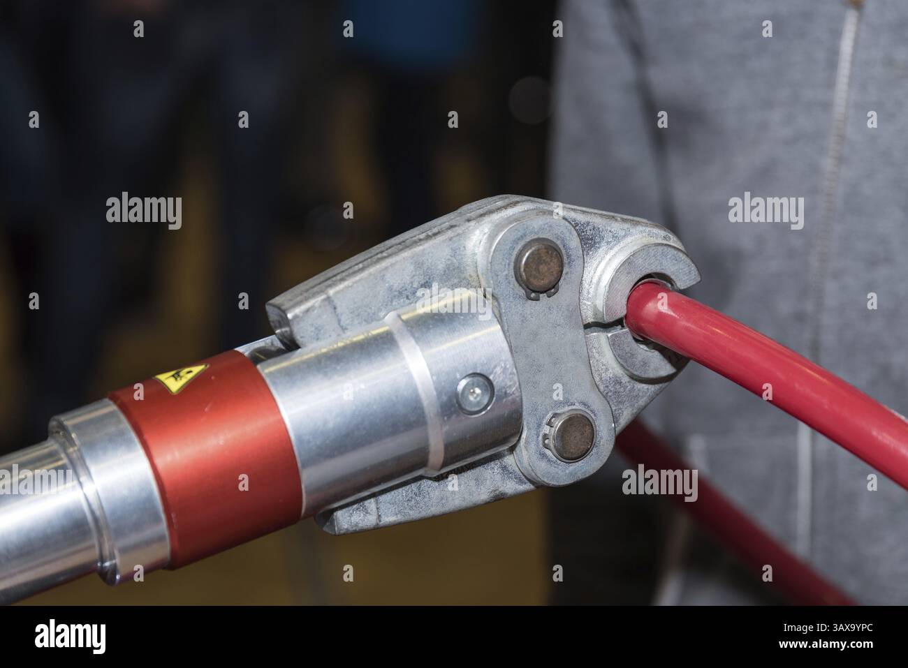 Connecting the hose with a clamping machine - Clamp close-up Stock ...